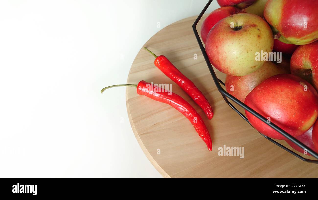 Red chili peppers and apples on a light background Stock Photo - Alamy