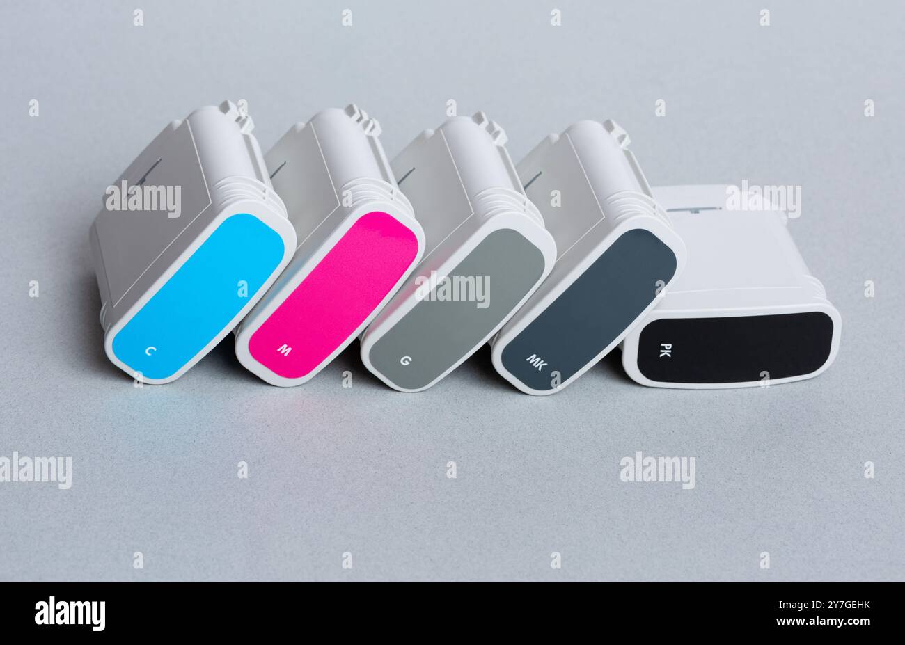 Cartridges color for wide format plotter on grey background. Bright ...