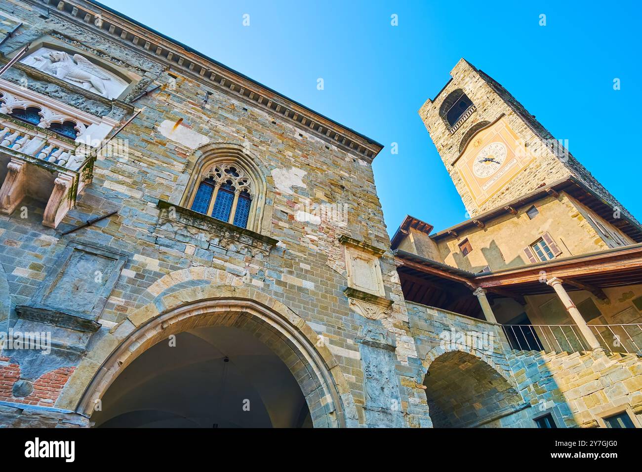 The medieval clocktower of Palazzo della Podesta and the white carved ...