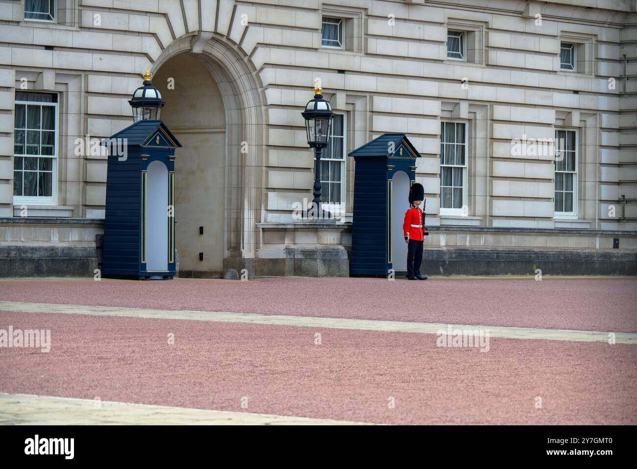 One of the Kings Guards in front of the Palace behind the gates at ...