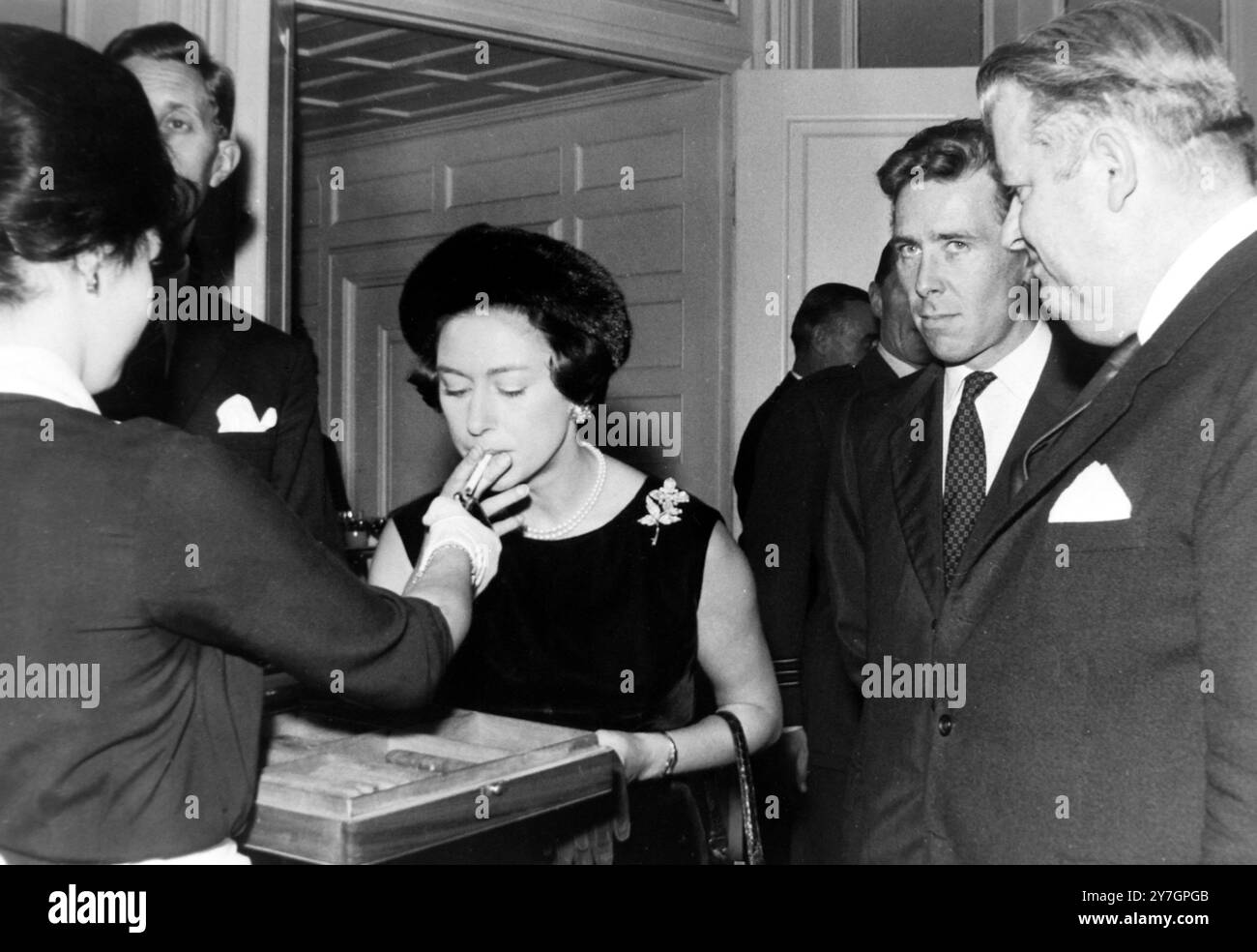 3 OCTOBER 1964 A waitress lights a cigarette for Princess Margaret as ...