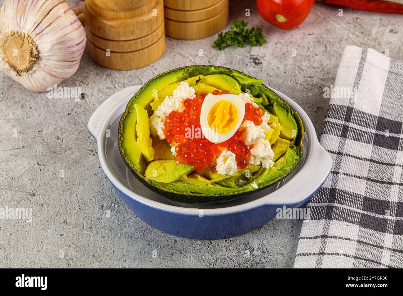 Avocado with red caviar and quil egg and soft cheese Stock Photo - Alamy