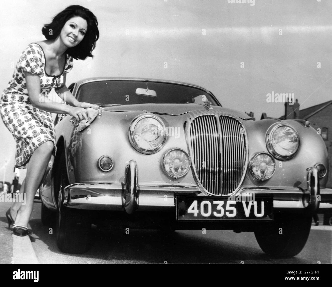 MAUGHAN SUSAN POLISHES DAIMLER CAR IN BLACKPOOL / ; 21 SEPTEMBER 1964 ...