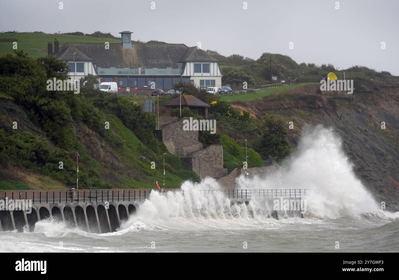 Waves crash against the promenade during wet and windy weather in ...