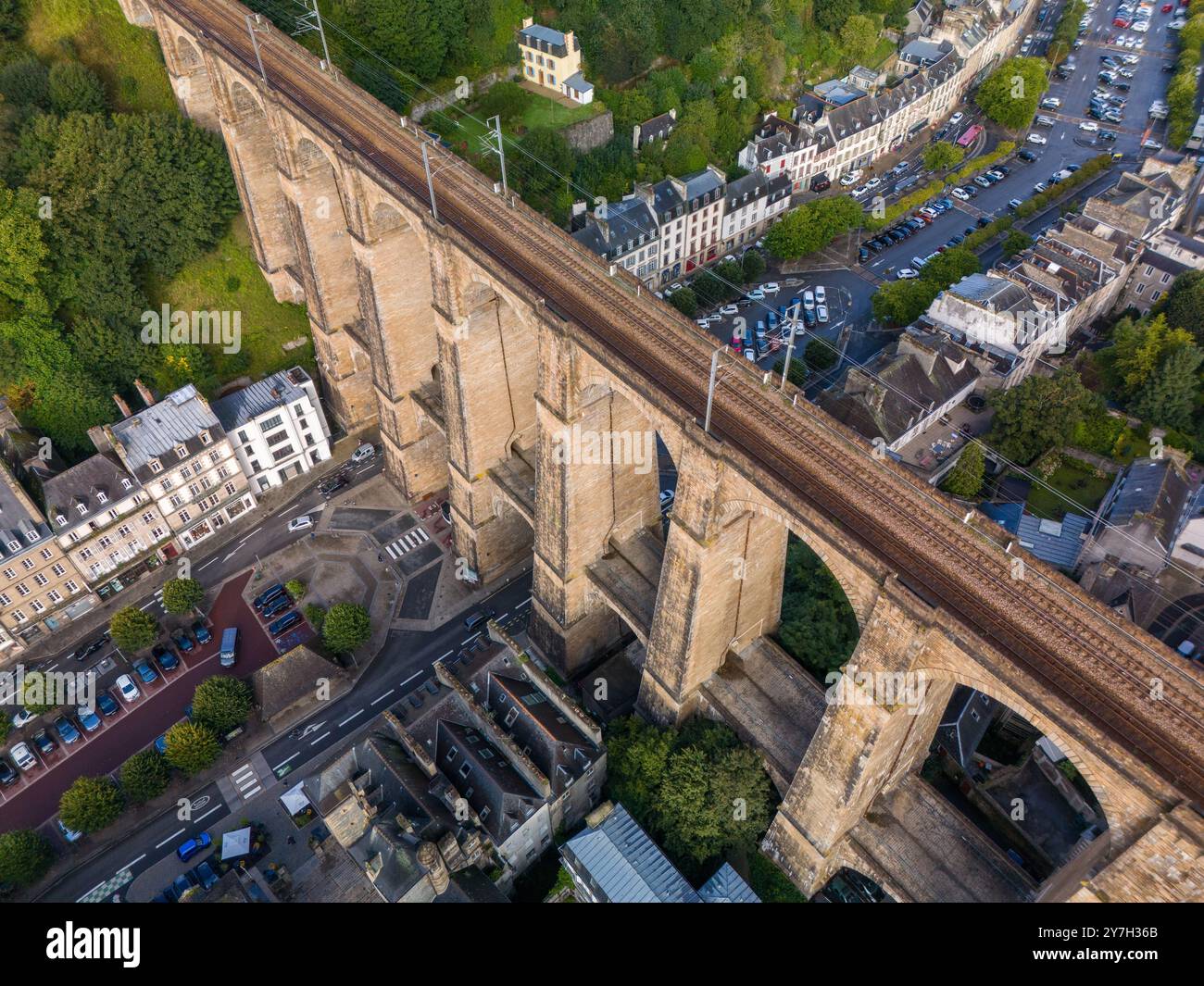Aerial view of a historic stone viaduct in a small town with ...