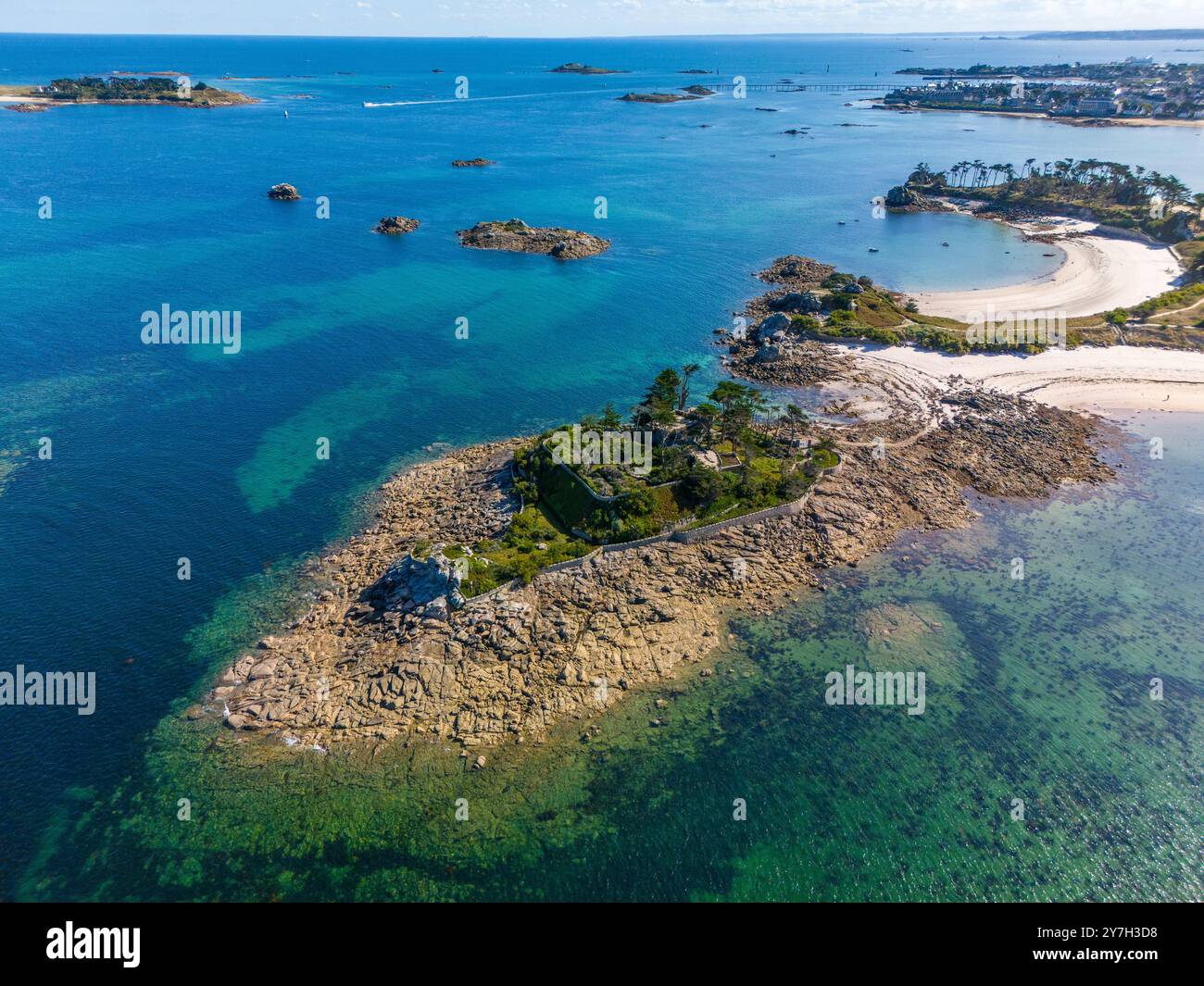 Aerial view of a scenic coastal landscape with clear blue waters, rocky ...