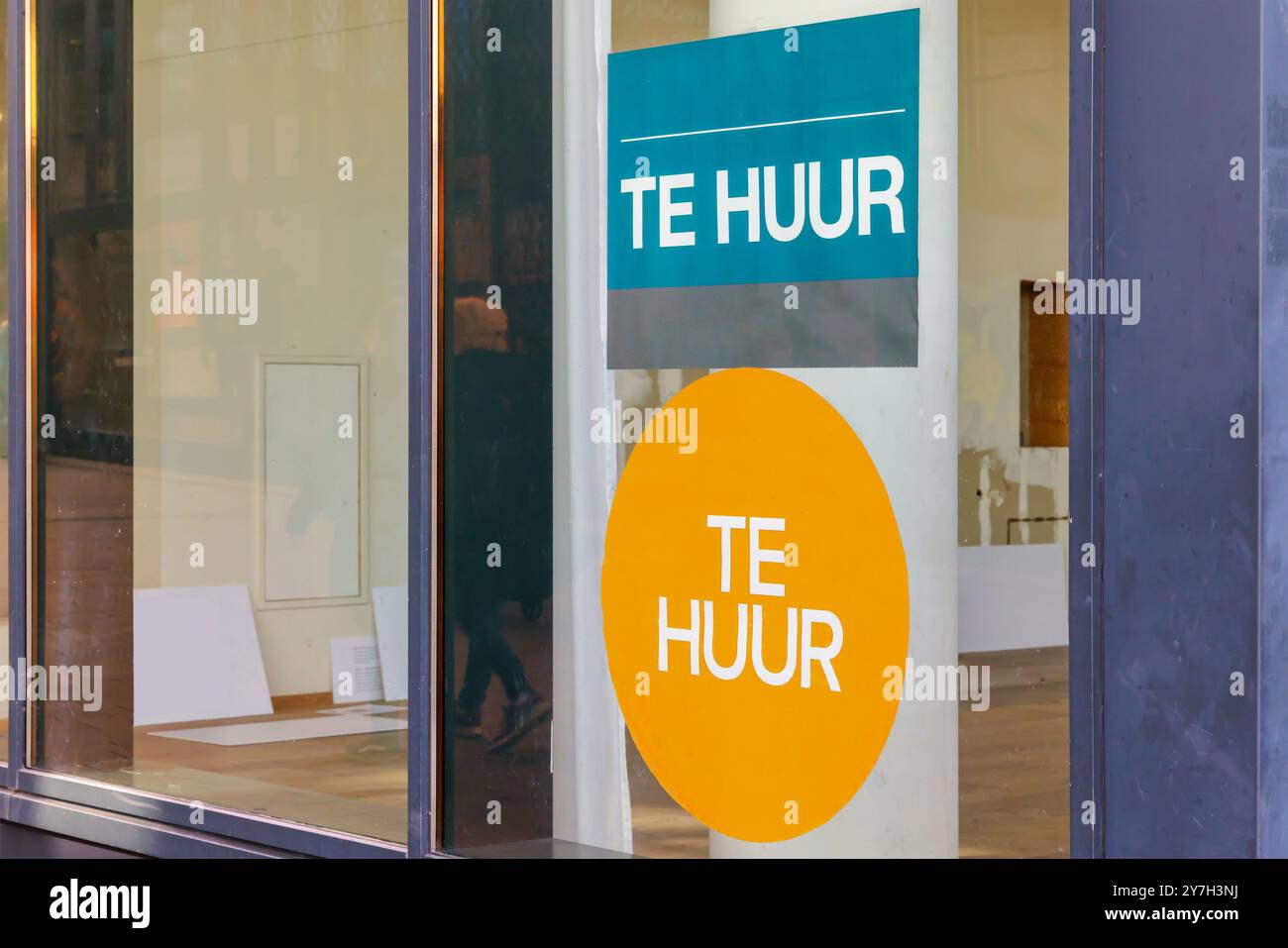 Dutch signs with the text 'for rent' on an empty city store window ...