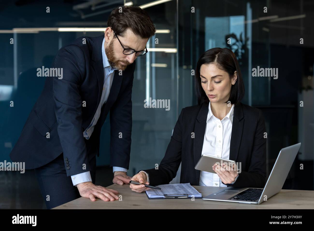 Business professionals engaged in workplace discussion over project ...