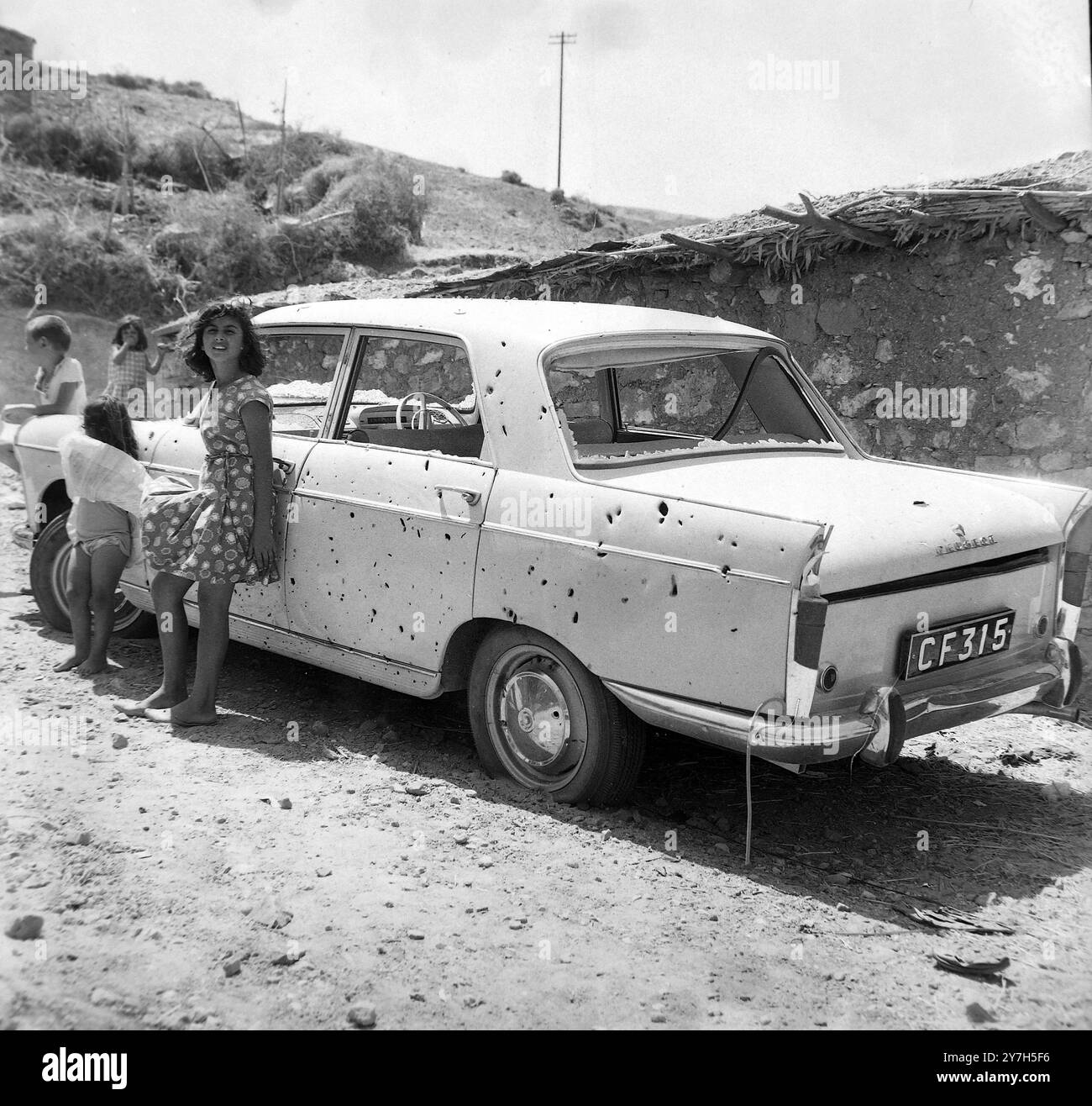 12 AUGUST 1964 A car riddled with machine gun bullets following a Greek ...