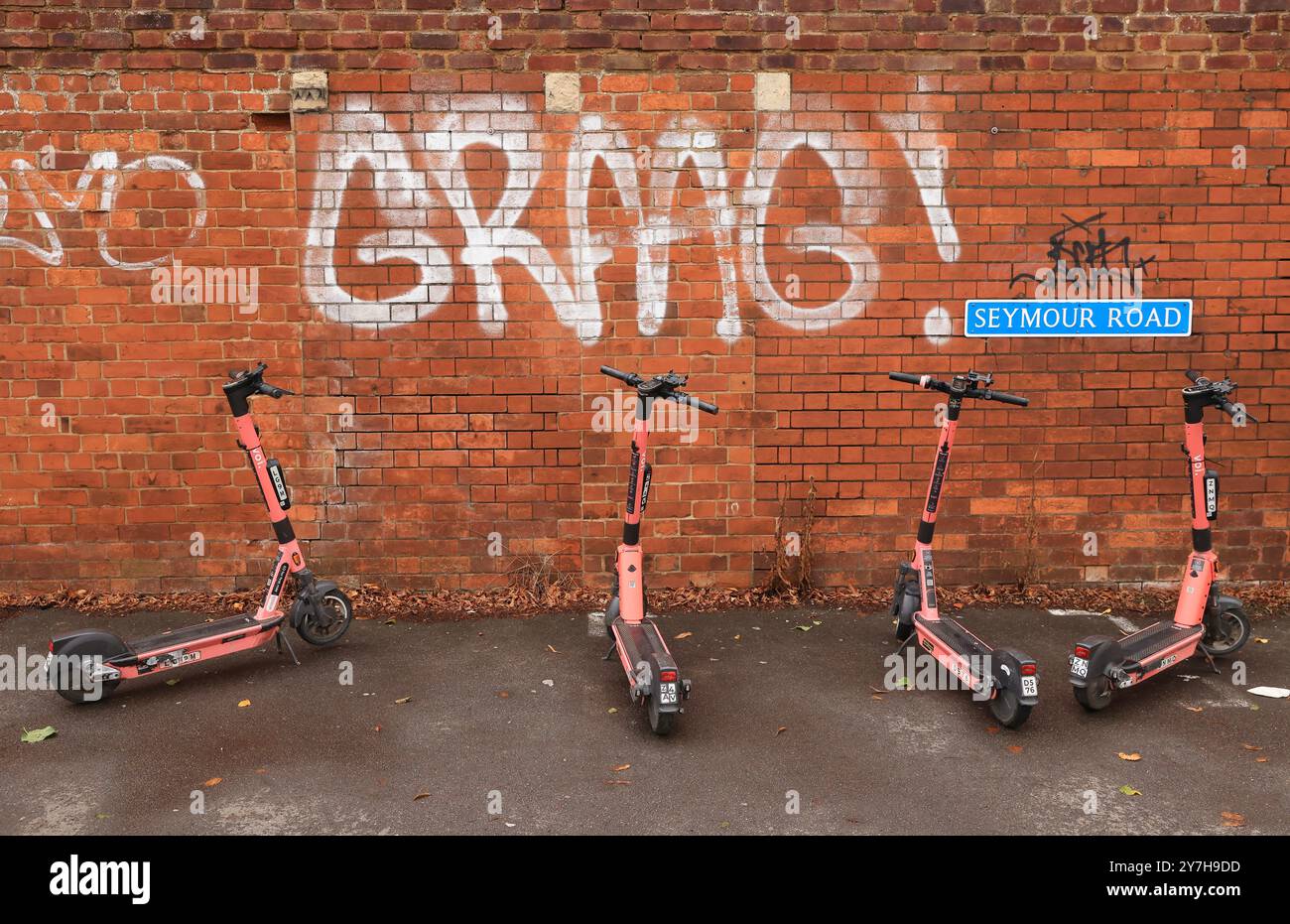 A modern urban scene with e bikes and a graffiti wall in a busy city ...