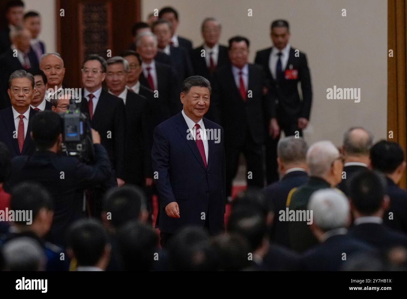 Chinese President Xi Jinping, center, is followed by high-ranking ...