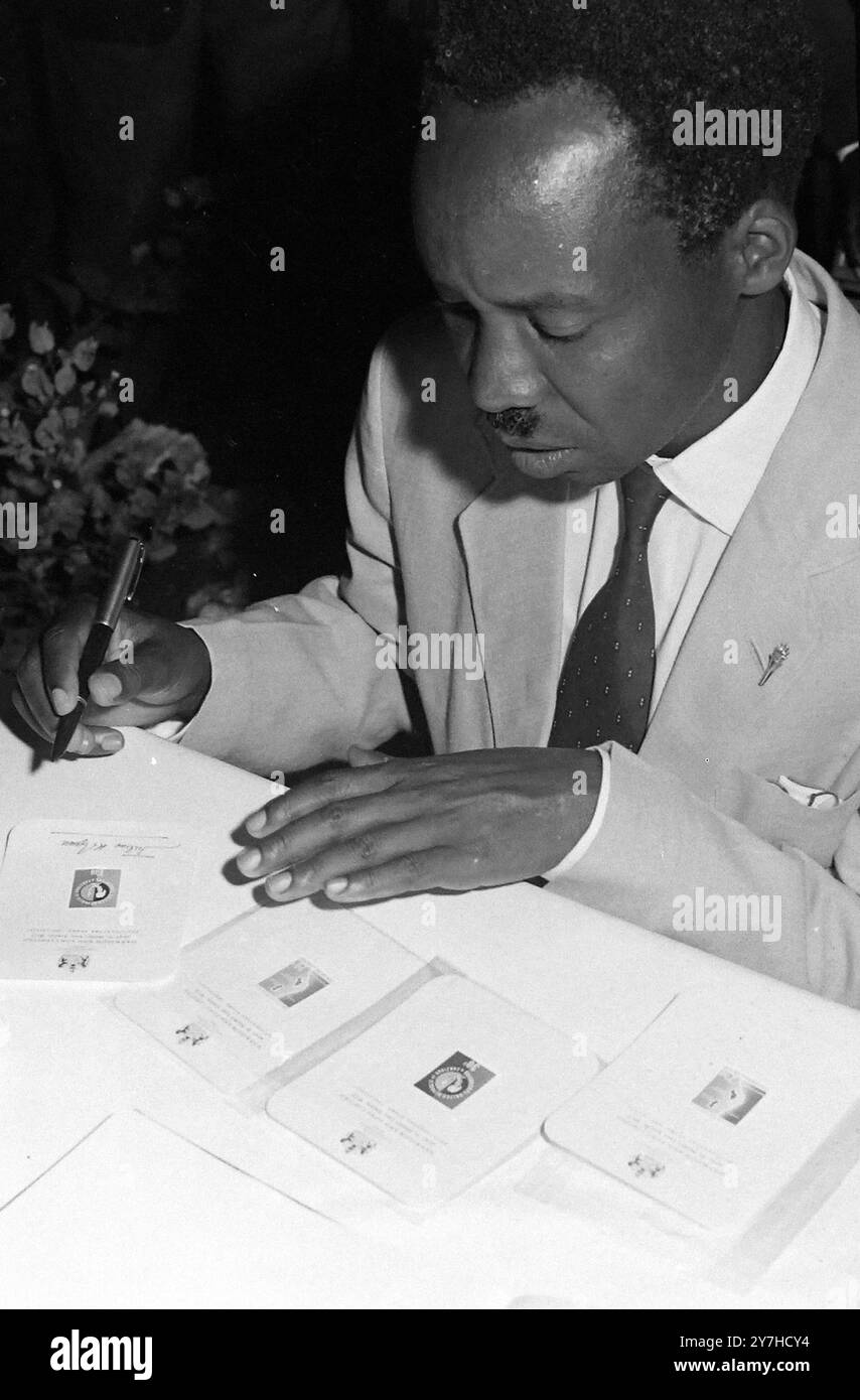 TANGANYIKAN PRESIDENT JULIUS NYERERE SIGNS COMMEMORATIVE STAMPS AT ...