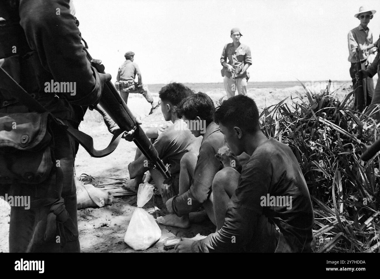 COMMUNIST VIET CONG GUERRILLAS UNDER GUARD IN LONG TOAN IN VIETNAM ; 1 ...
