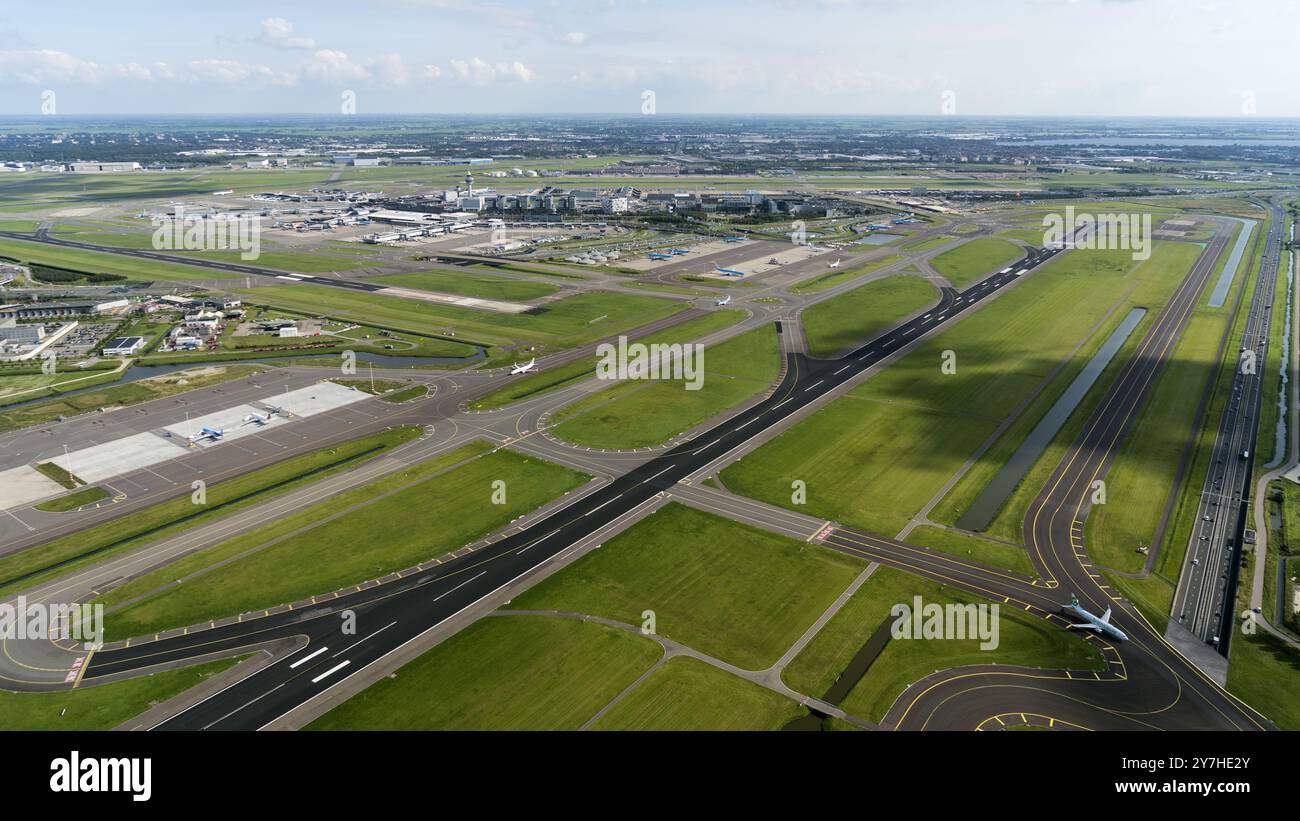 Overview of Schiphol Airport from the center runway with pier and a ...
