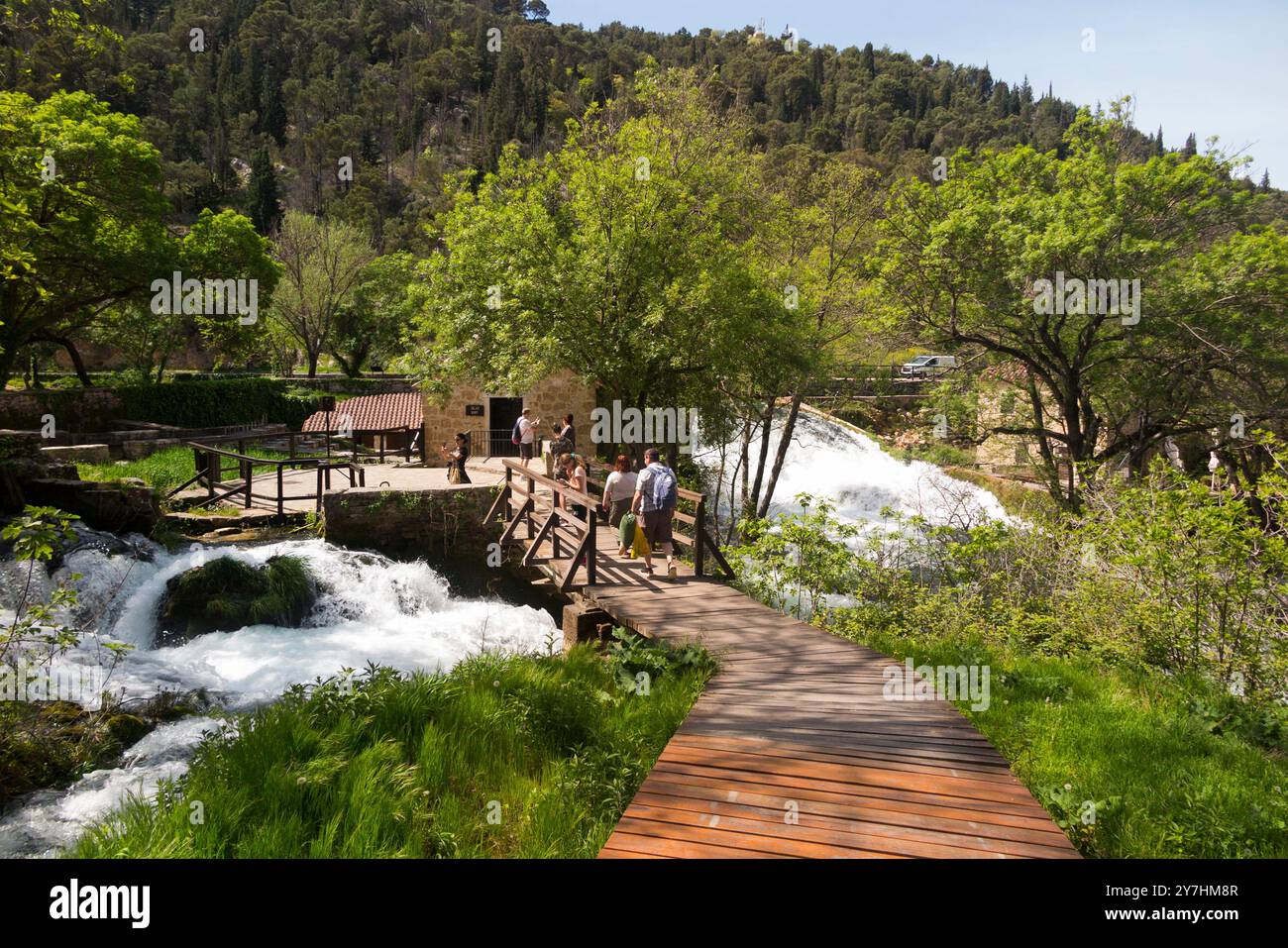 Wooden boardwalk running parallel to the Kirka river as it flows fast ...