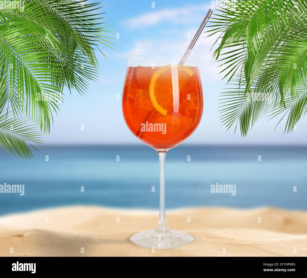 Summer beach with delicious Aperol Spritz cocktail, palm leaves and ...