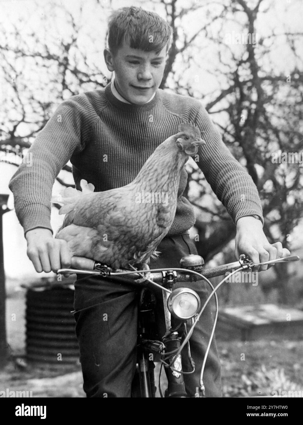 MALCOLM BAKER CYCLES WITH HETTY THE HEN IN SUFFOLK / ; 20 APRIL 1964 ...