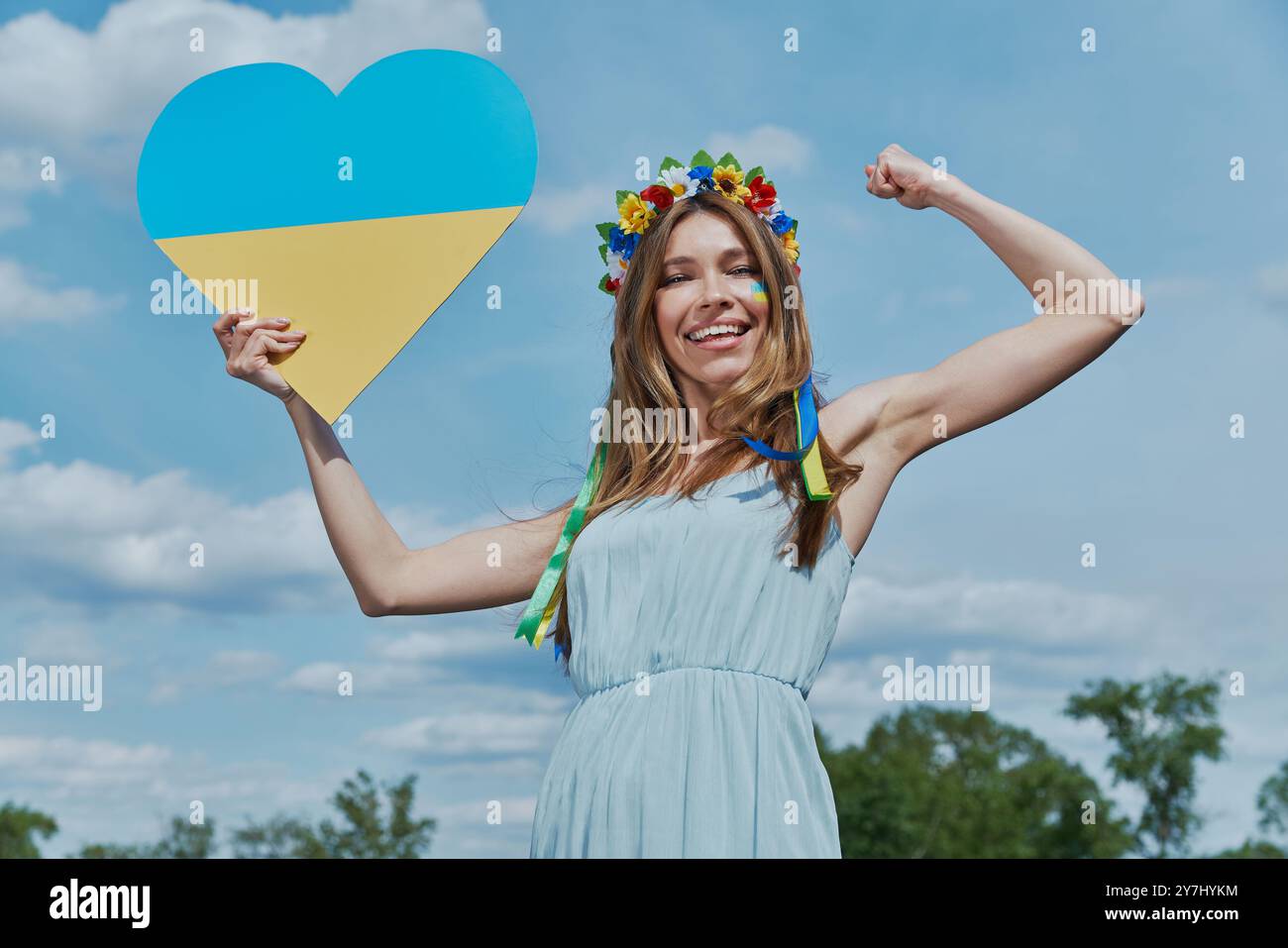 Beautiful Ukrainian woman in floral crown holding heart shape national ...