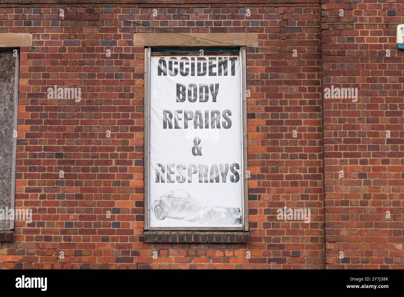 Black and white sign outside car bodyshop saying accident body repairs ...