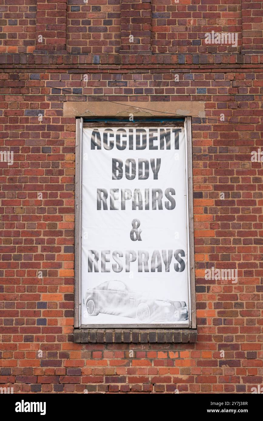 Black and white sign outside car bodyshop saying accident body repairs ...