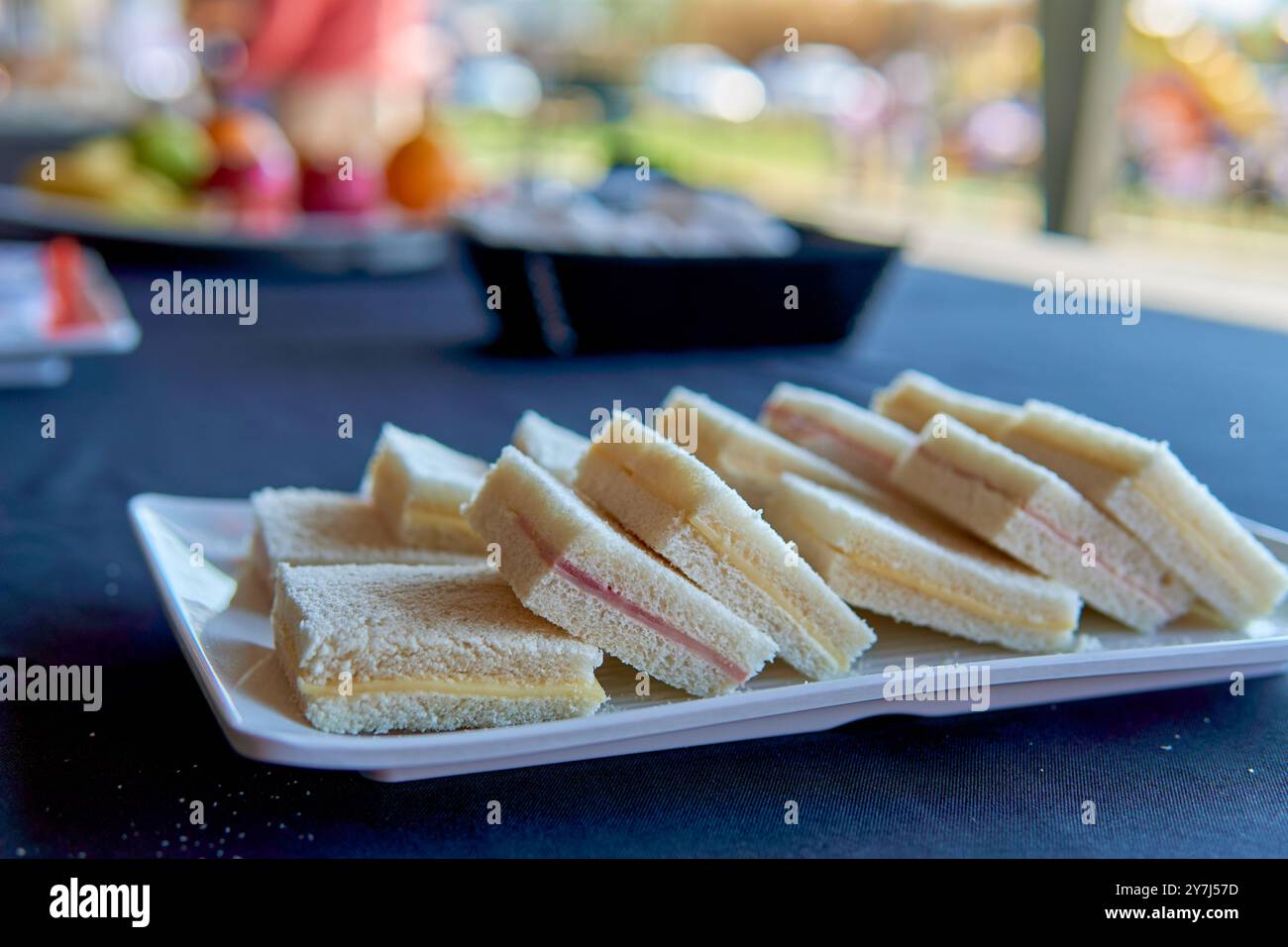 ham and cheese sandwiches de miga, typical argentinian snack on a table ...