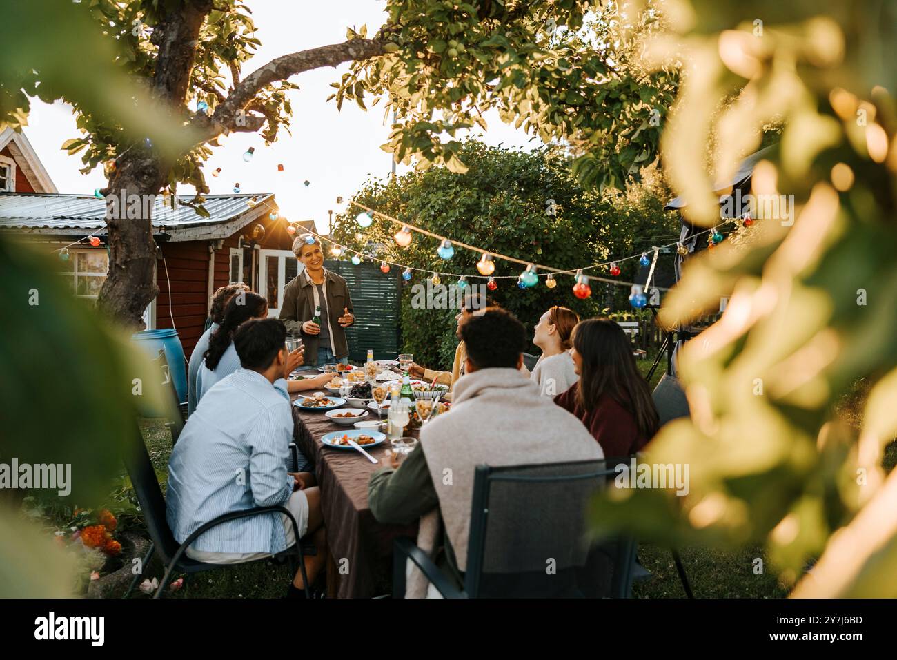 String light decoration with man giving speech to male and female ...