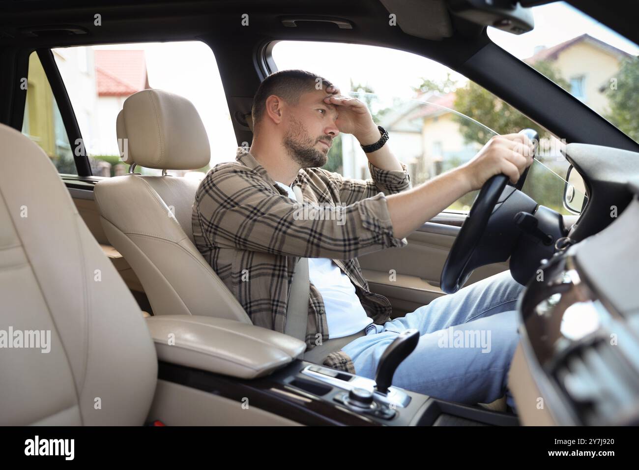 Tired man holding steering wheel while driving car Stock Photo - Alamy