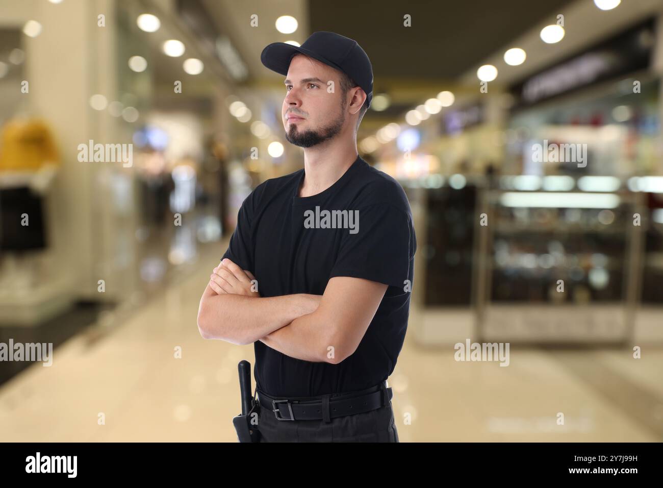 Portrait of confident security guard in shopping mall Stock Photo - Alamy