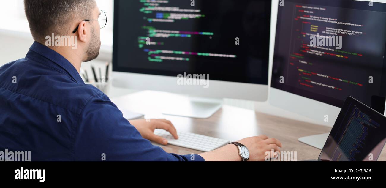 Programmer working at desk in office, back view. Banner design Stock ...