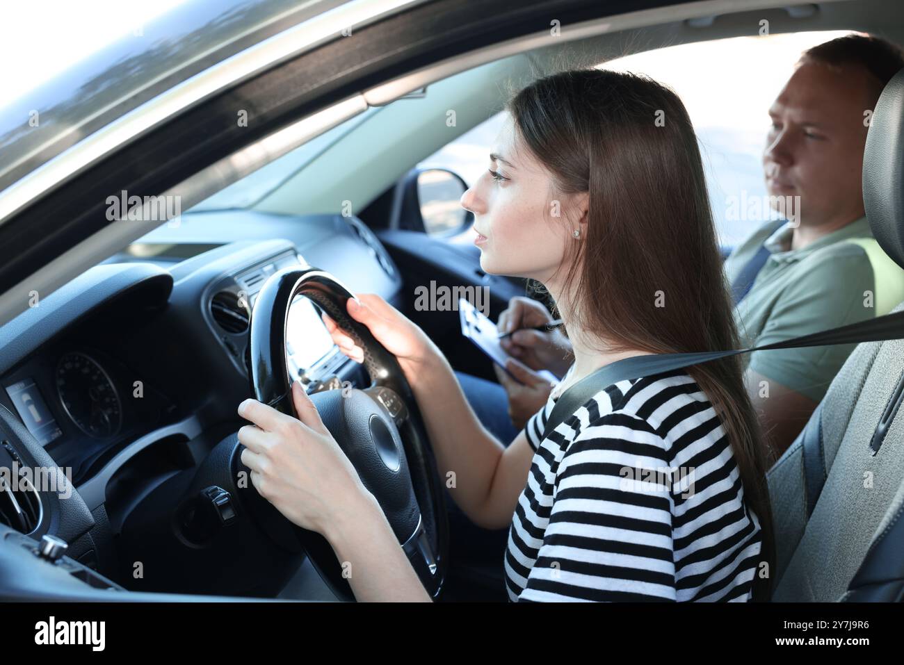 Driving school. Student passing driving test with examiner in car Stock ...