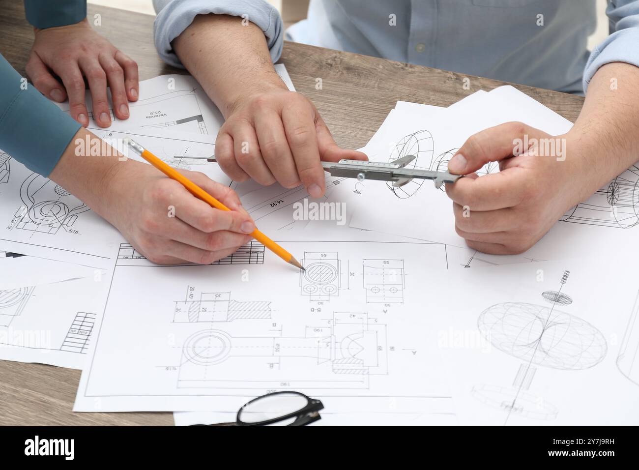 Engineers working with project, closeup. Different technical drawings ...