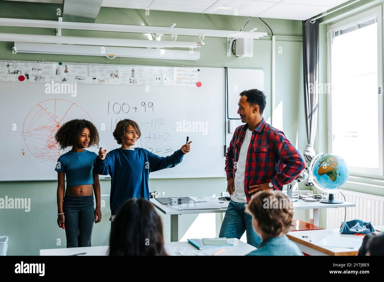 Professor with students explaining mathematics equations to pupils in ...