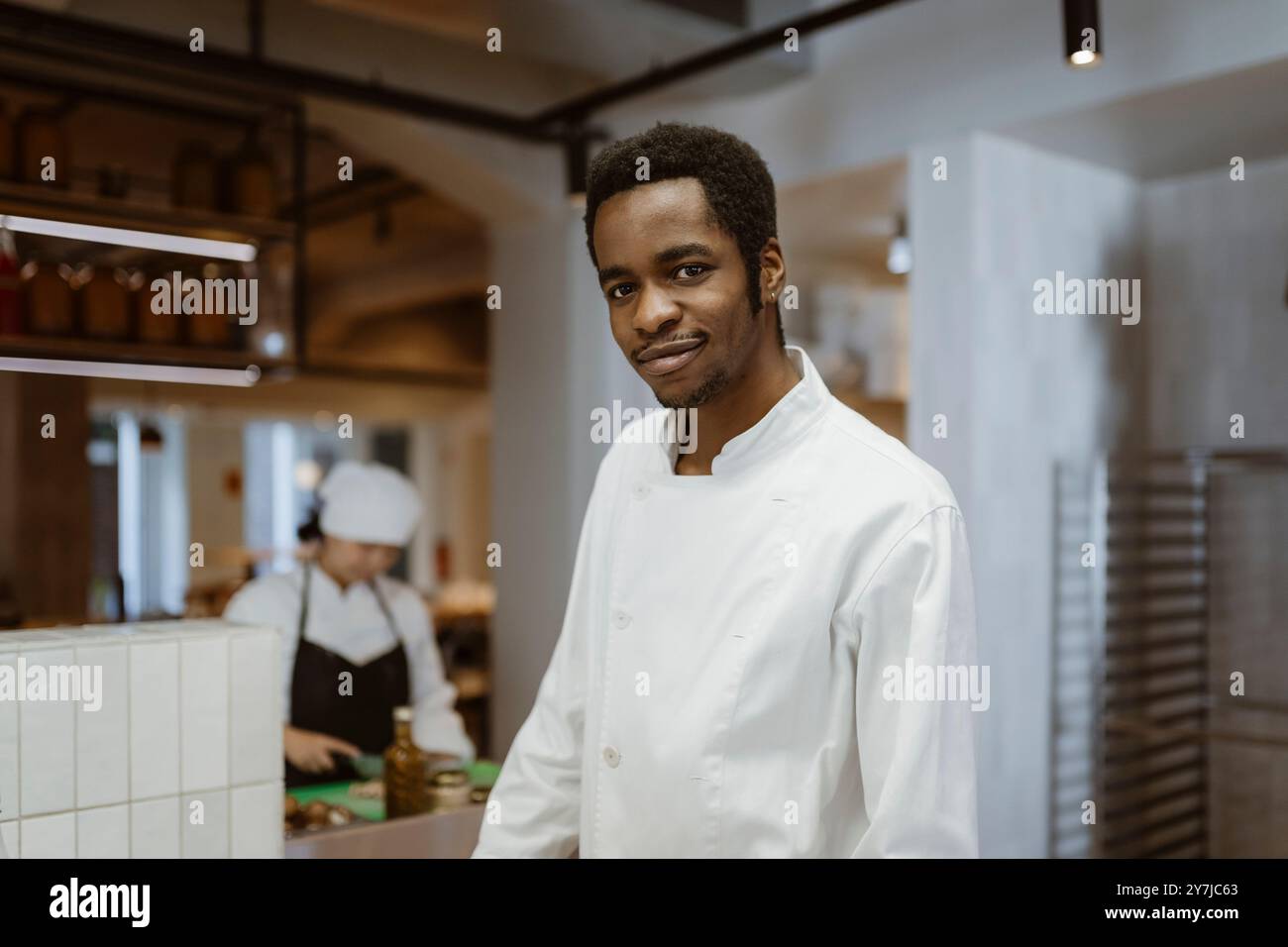 Portrait smiling young chef hi-res stock photography and images - Alamy