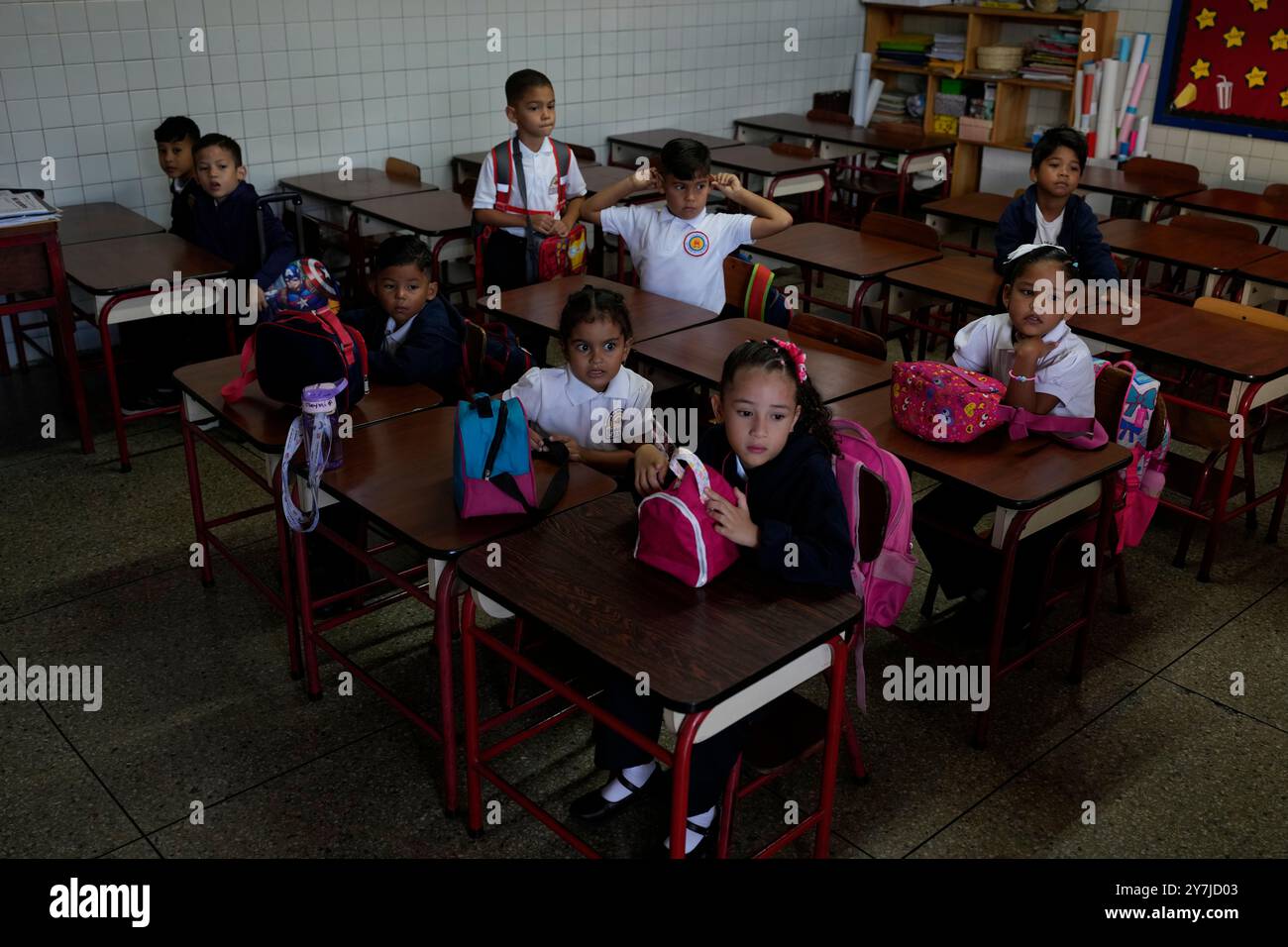 First graders attend their first day back to school in Caracas ...