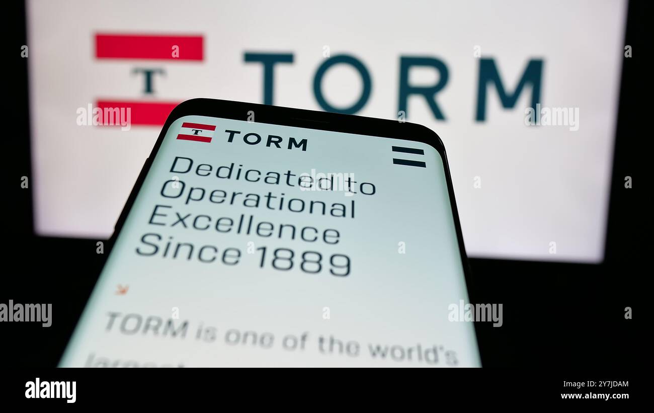 Mobile phone with website of Danish shipping company TORM plc on screen ...