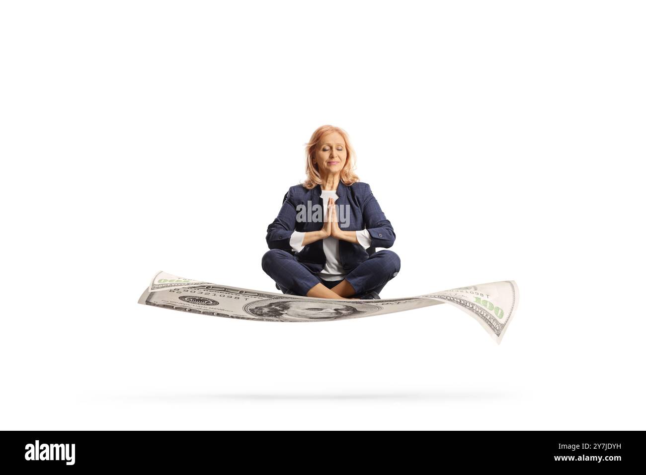 Businesswoman sitting on a paper money bill in a meditation pose ...