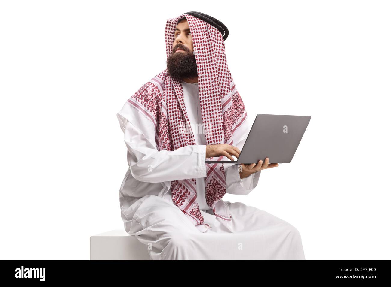 Saudi arab man with a laptop computer sitting isolated on white ...