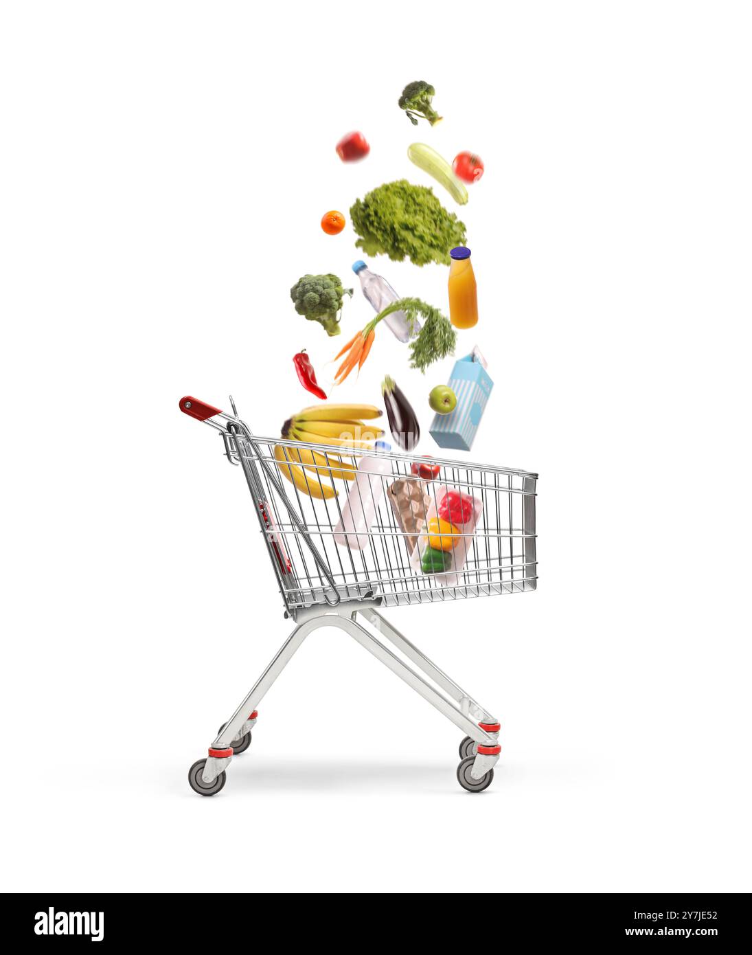 Groceries falling inside a shopping cart isolated on white background ...