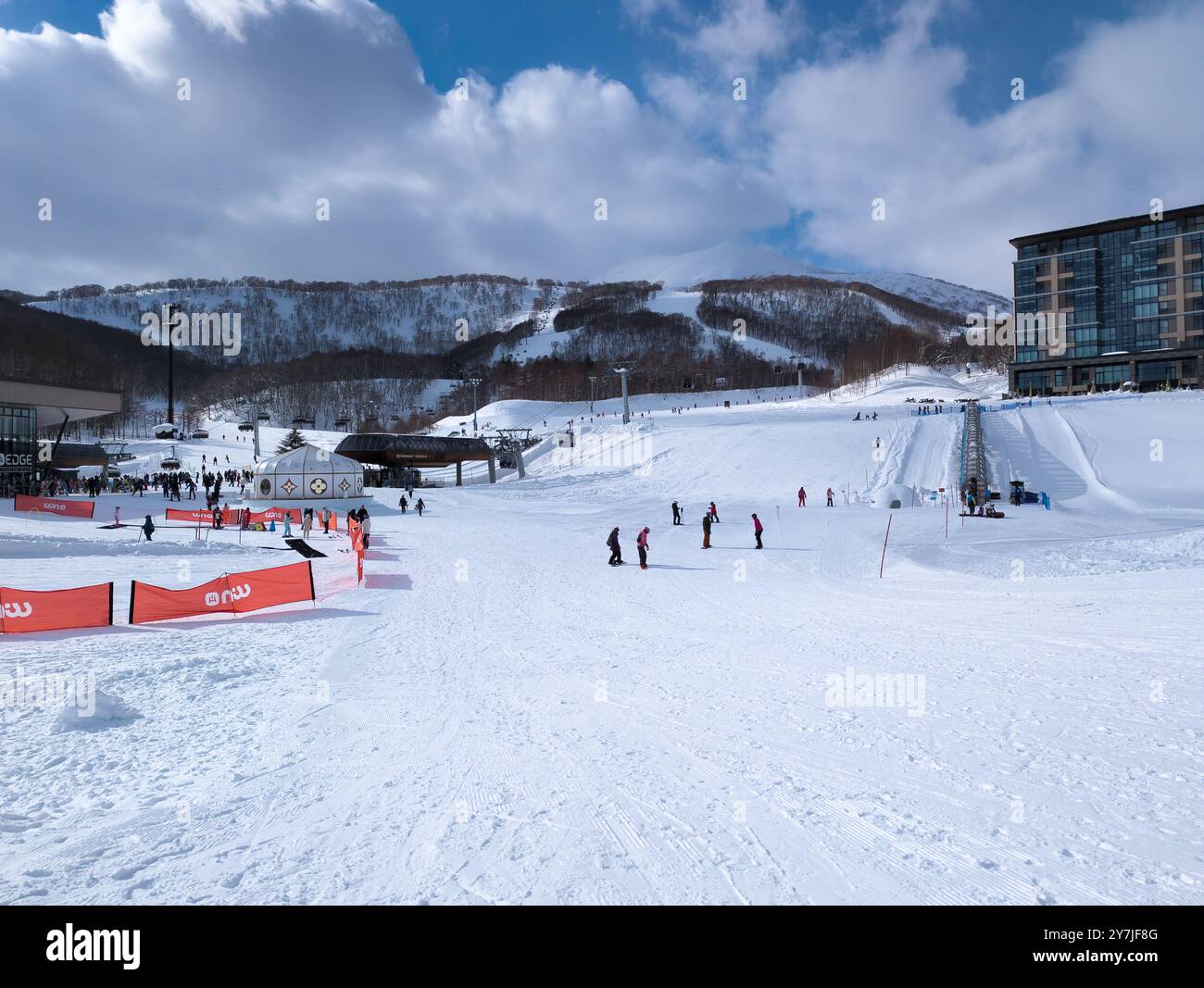Snowboarders and skiers on the lower pistes of Niseko Hanazono ski ...