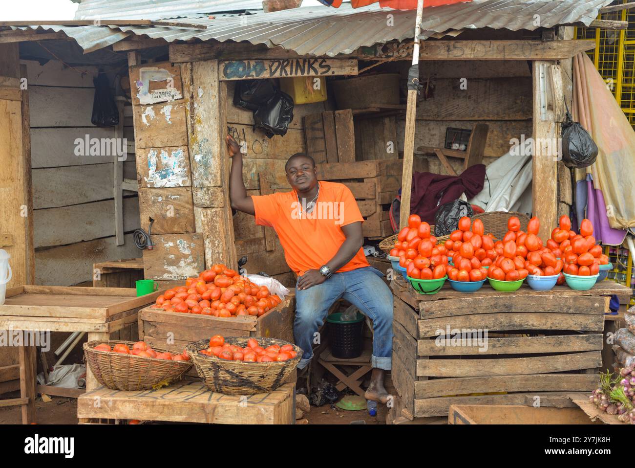 Aman sells tomatoes at his stall in Ggaba Market - Kampala Stock Photo ...