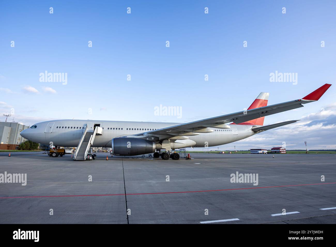 Wide body passenger jet plane with boarding stairs at the airport Stock ...