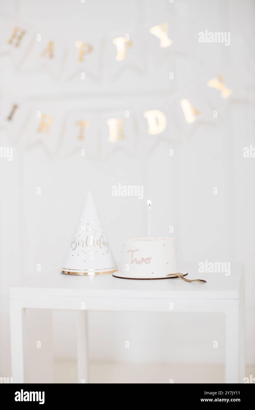 Elegant birthday setup with cake and party hat Stock Photo - Alamy