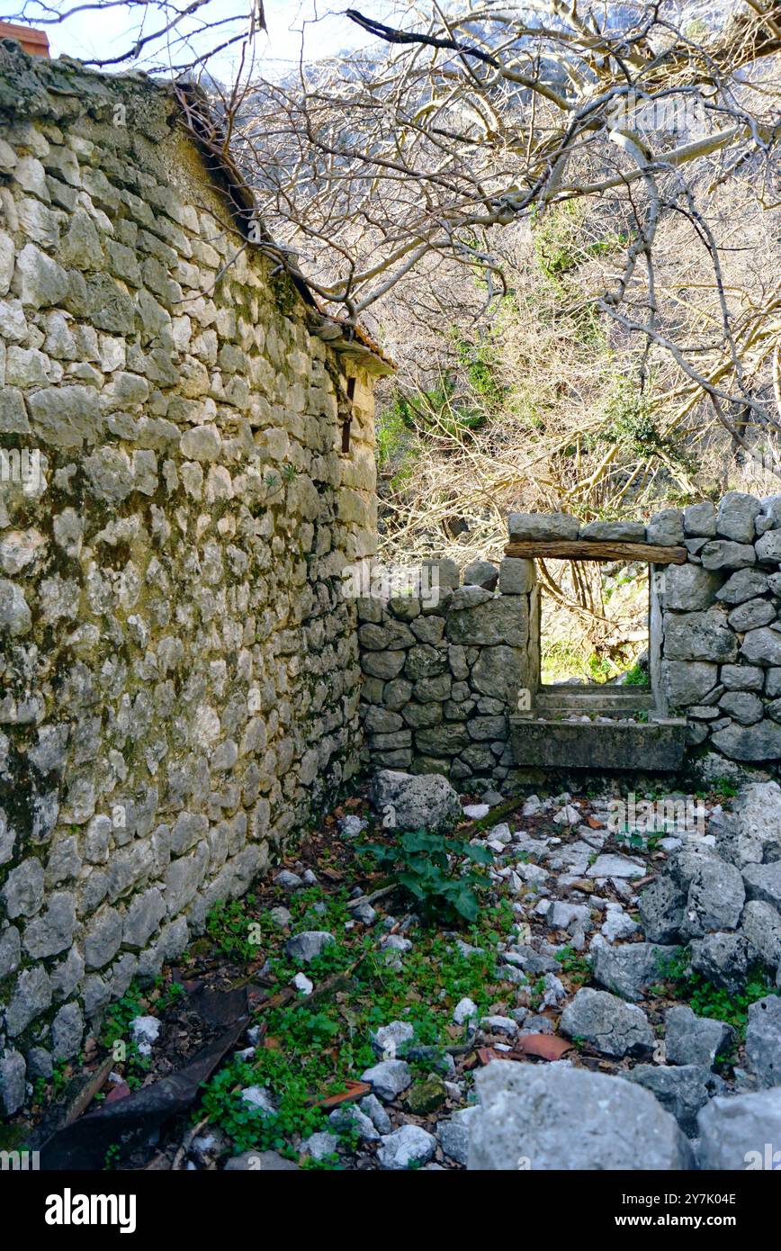 Inside an house destroyed by an earthquake: a collapsed wall, a collapsed roof and floors with ...
