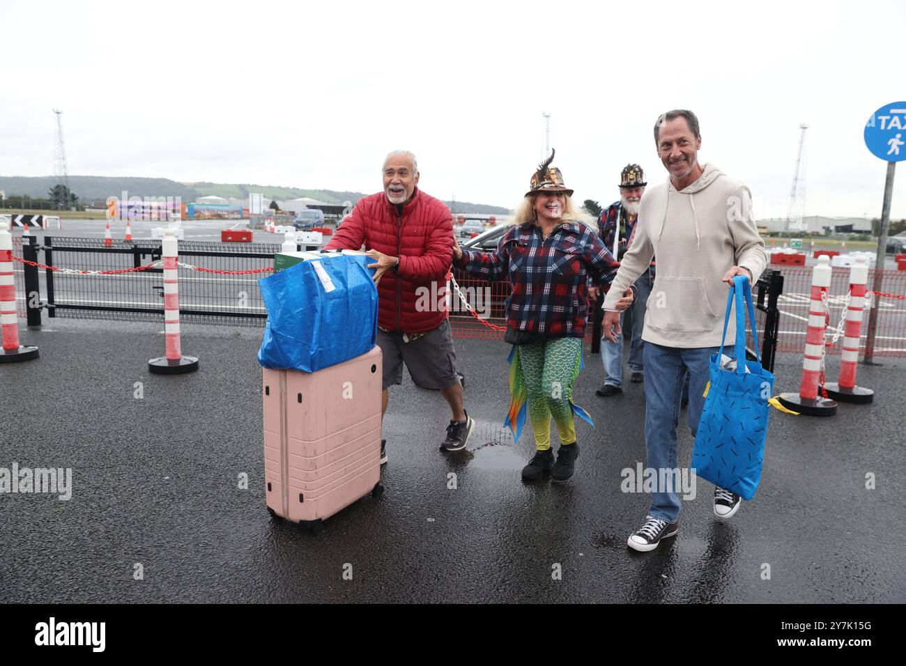 Melody Thor Hennessee (centre) prepares to board the Villa Vie Odyssey ...