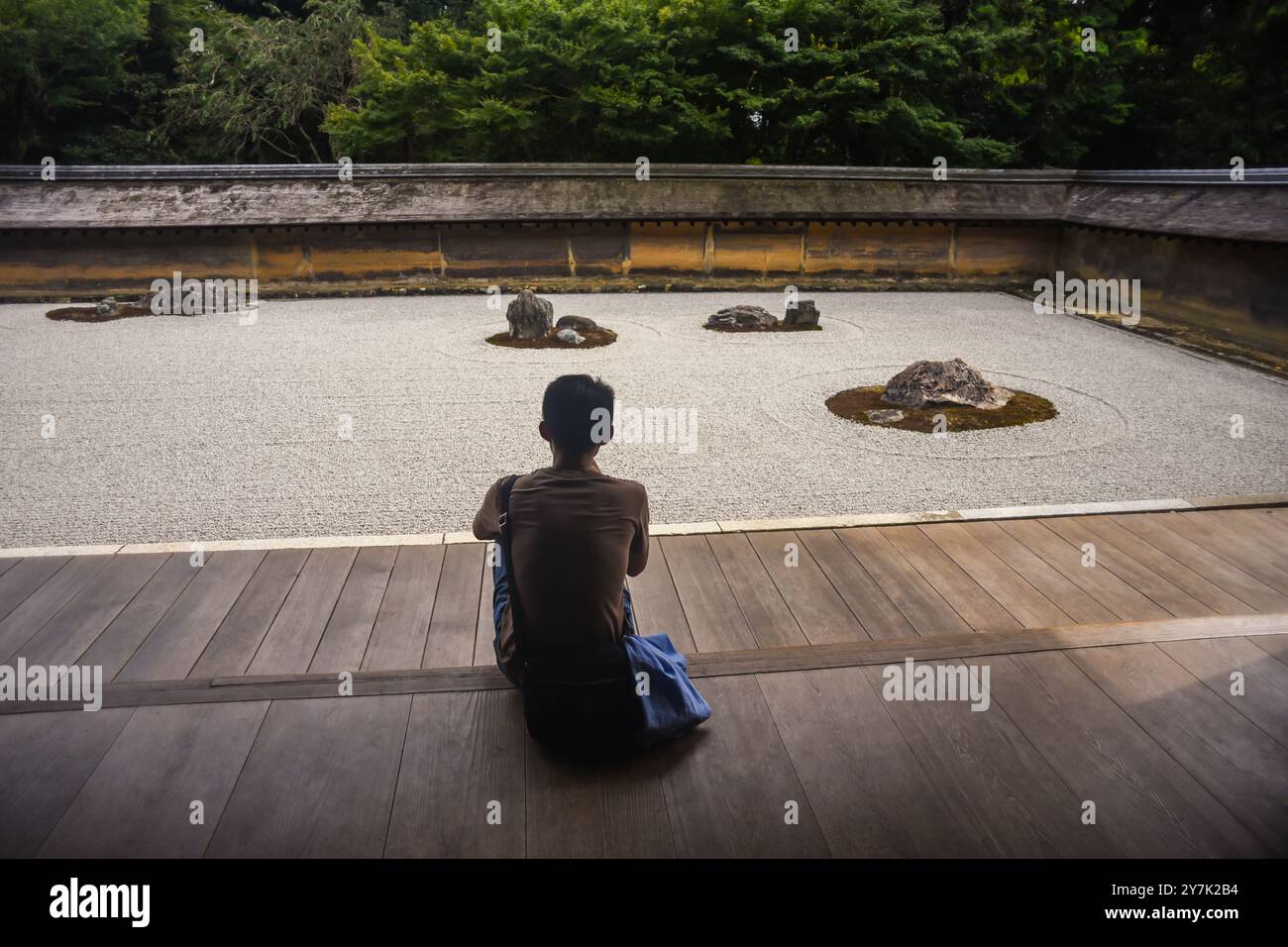 One man meditates at Japanese zen garden, Ryoan-Ji Temple in Kyoto ...