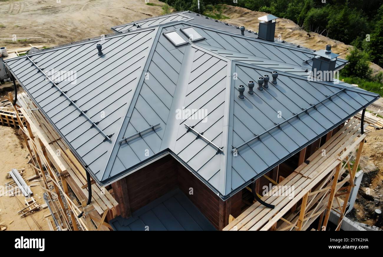 Aerial view of house retro roof panel with standing seam, fastener ...