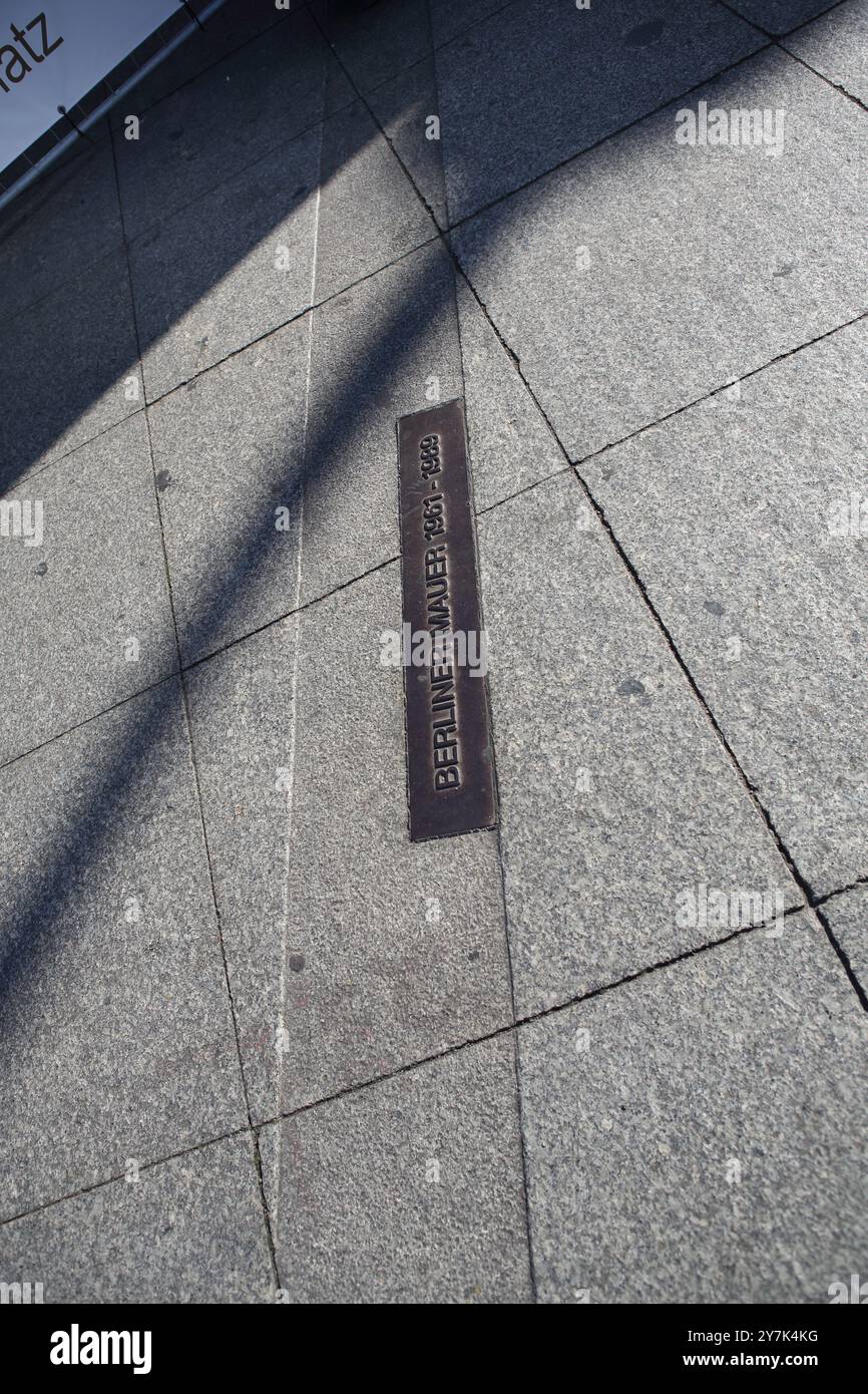Outlines on a sidewalk in Potsdamer Platz & a sign showing where the ...