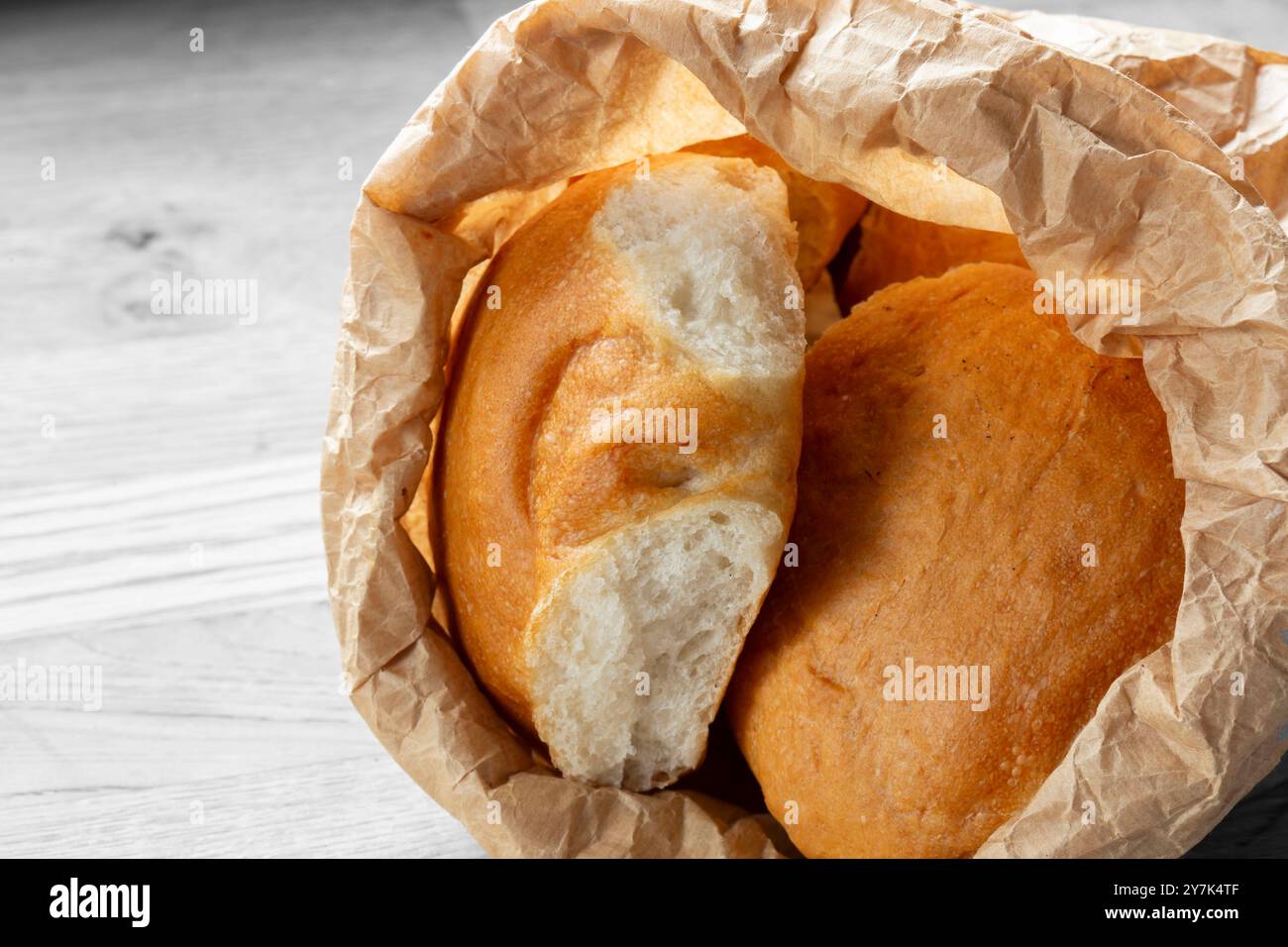 Freshly baked crusty bread roll buns cobs in a brown paper bag. Eco ...