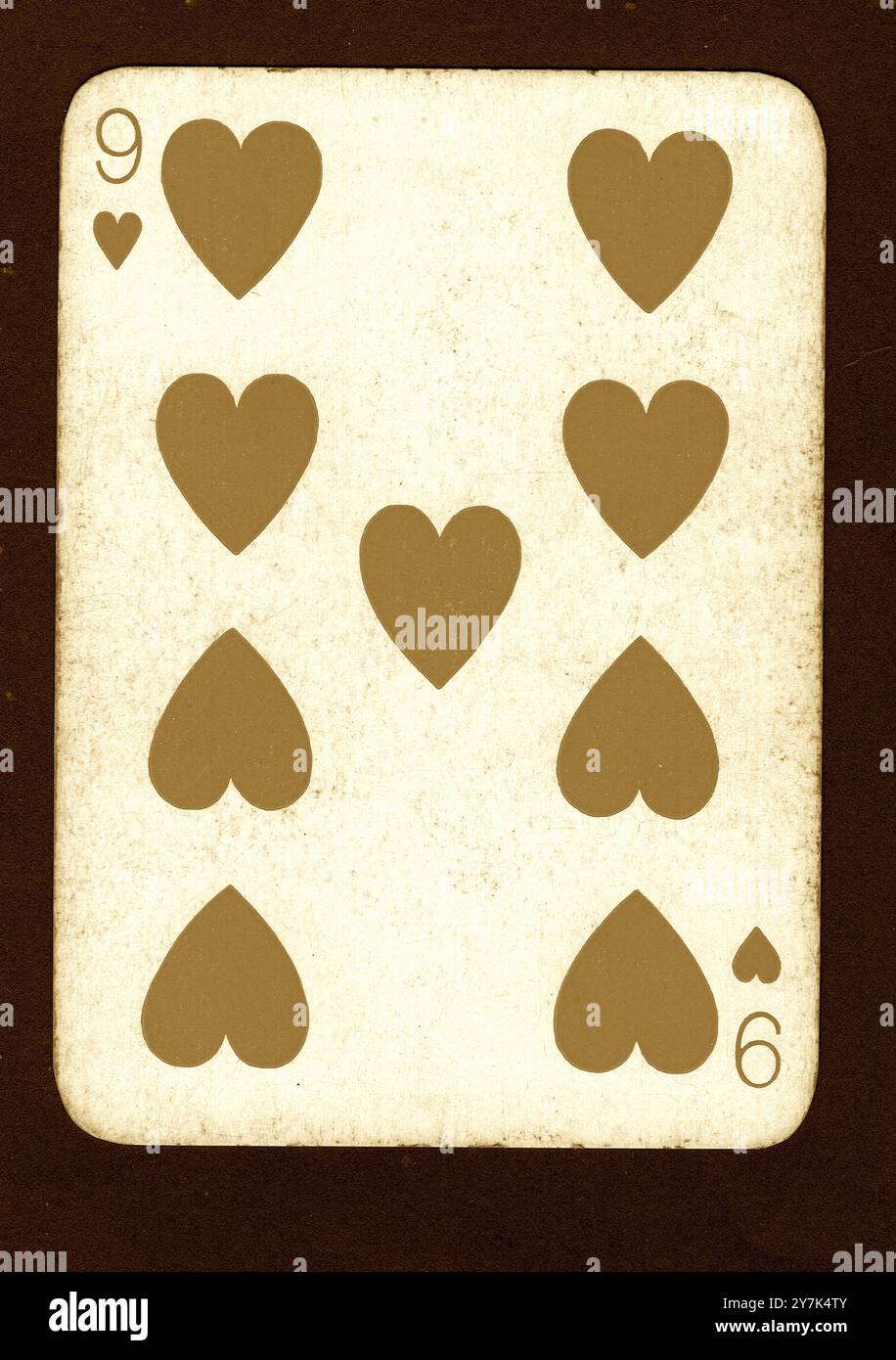 A vintage nine of hearts playing card in sepia on a black background ...
