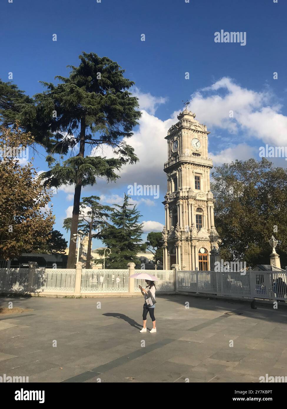 A tourist in front of Dolmabahce Palace Clock Tower in Istanbul, Turkey ...